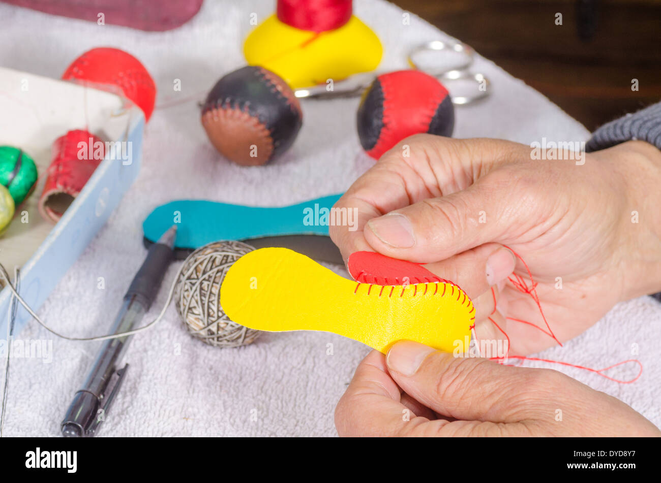Leather craft, male hands sewing traditional sport balls Stock Photo ...