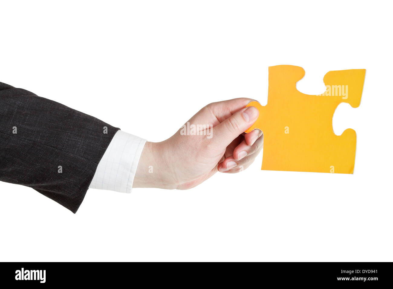 male hand holding big yellow paper puzzle piece isolated on white ...