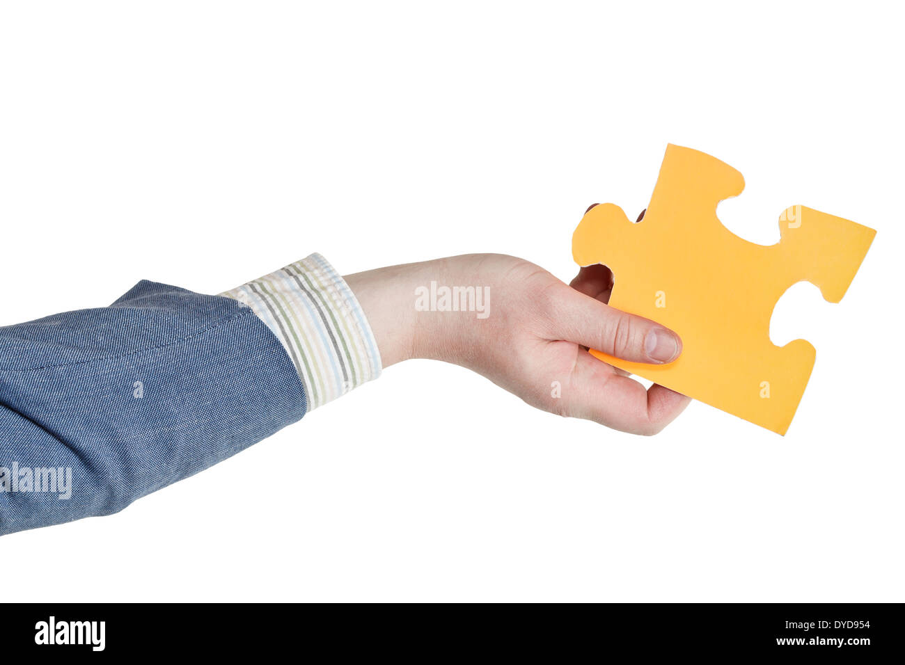 male hand holding big yellow paper puzzle piece isolated on white ...