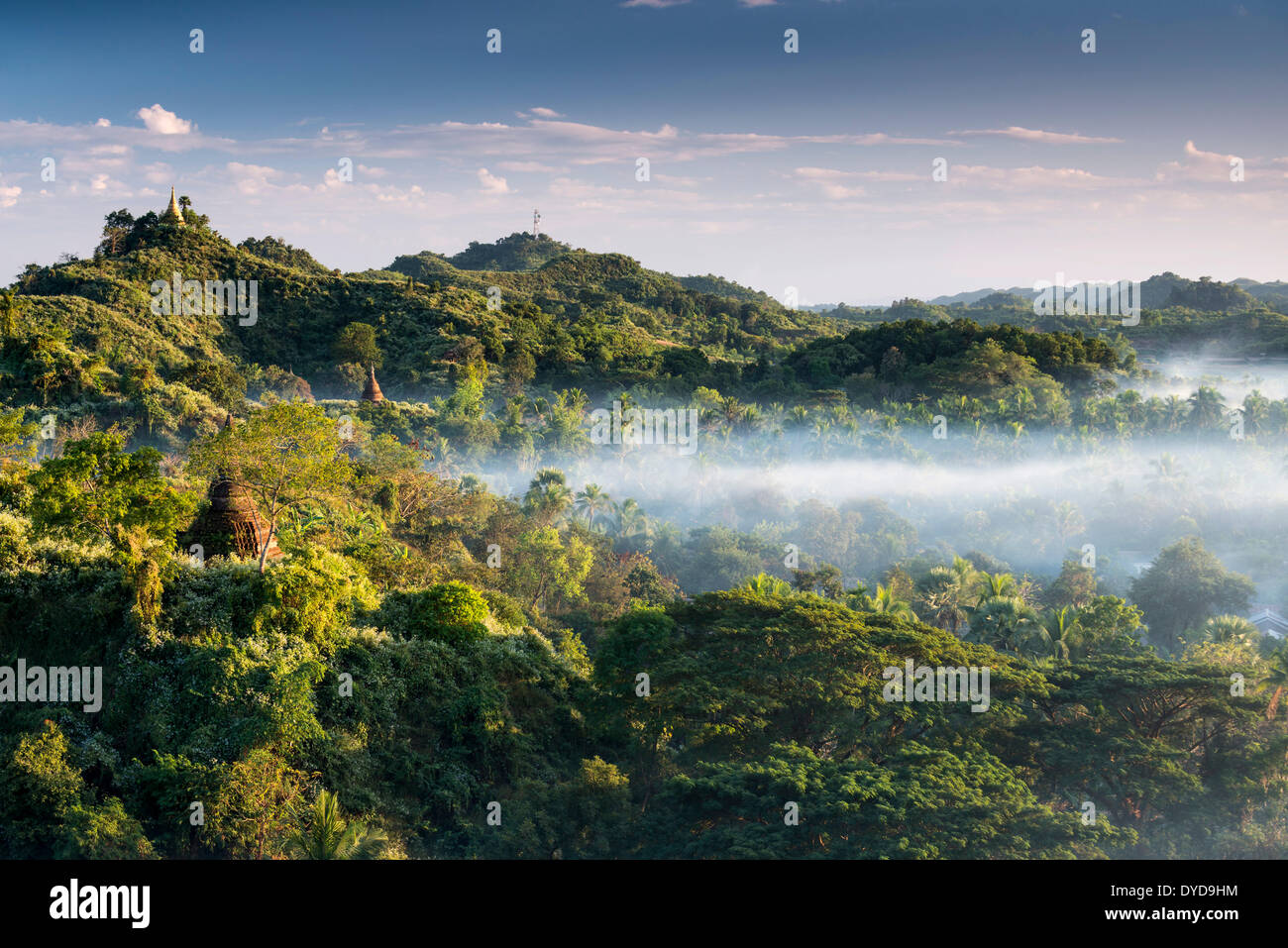 Pagodas surrounded by trees, in the mist, Mrauk U, Sittwe District ...