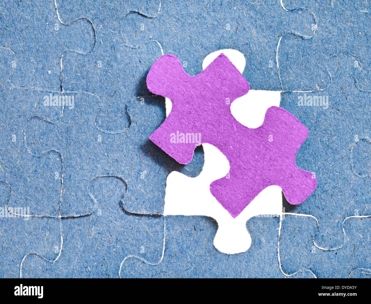 setting the last pink piece of puzzle in free space in assembled jigsaw ...