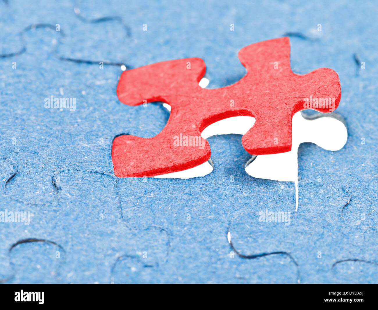 setting the last red piece of puzzle in free space in assembled jigsaw ...