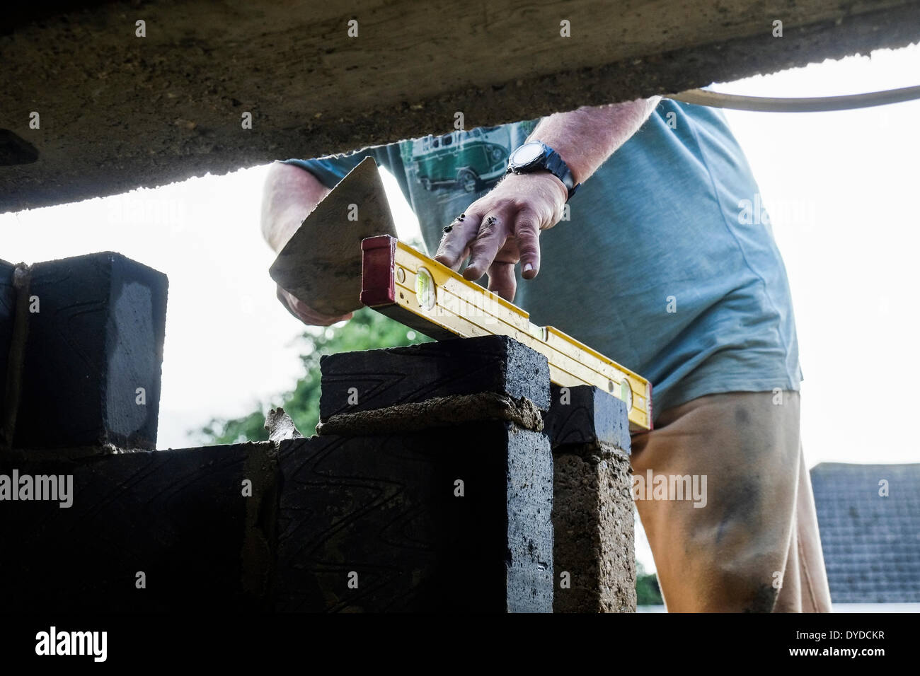 A bricklayer using a level during the building of a wall Stock Photo ...