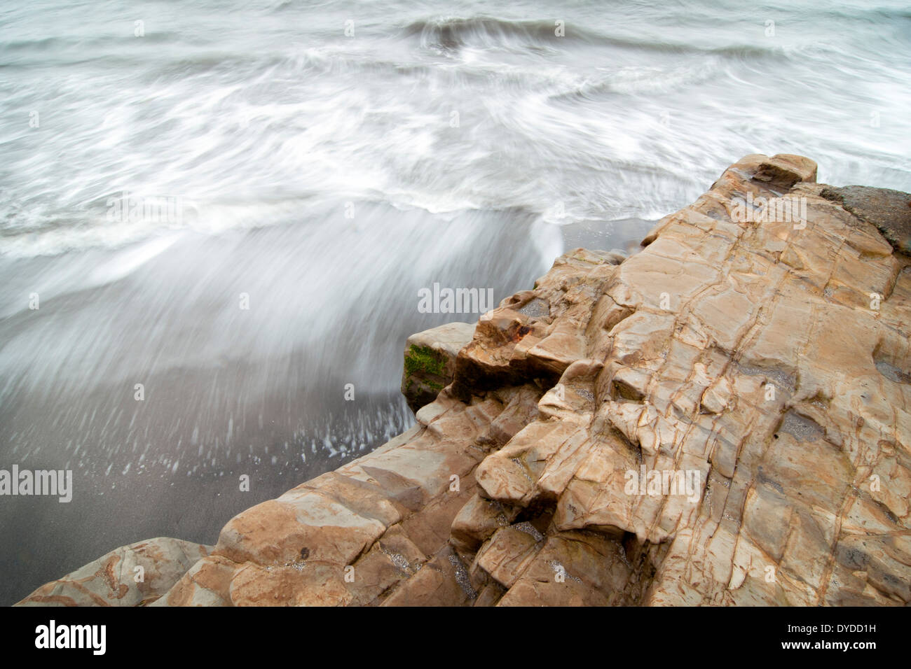 stormy sea waves surf near cracked cliff Stock Photo - Alamy
