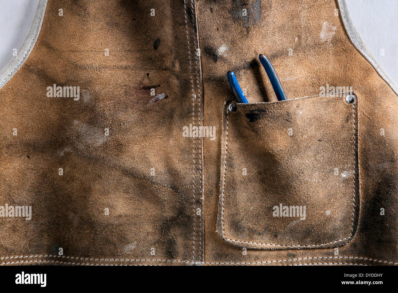Leather workshop apron with pliers in the pocket Stock Photo - Alamy