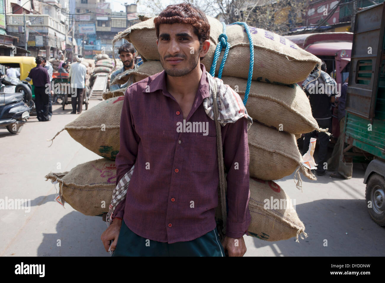 Indian man porter carrying heavy bags hi-res stock photography and ...