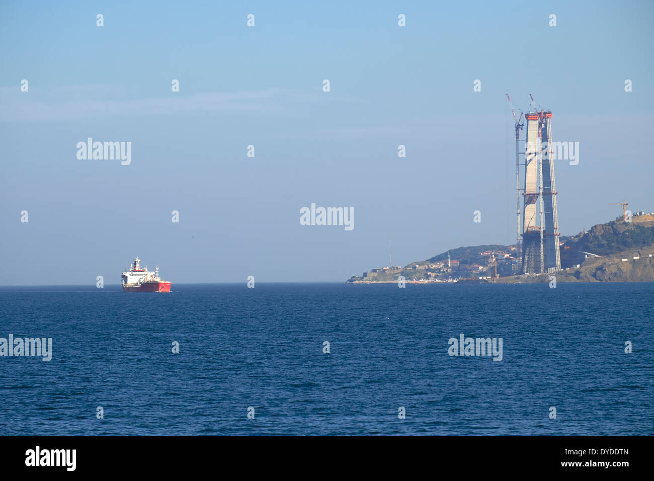 Container ship passing the new Third Bridge that is under construction ...