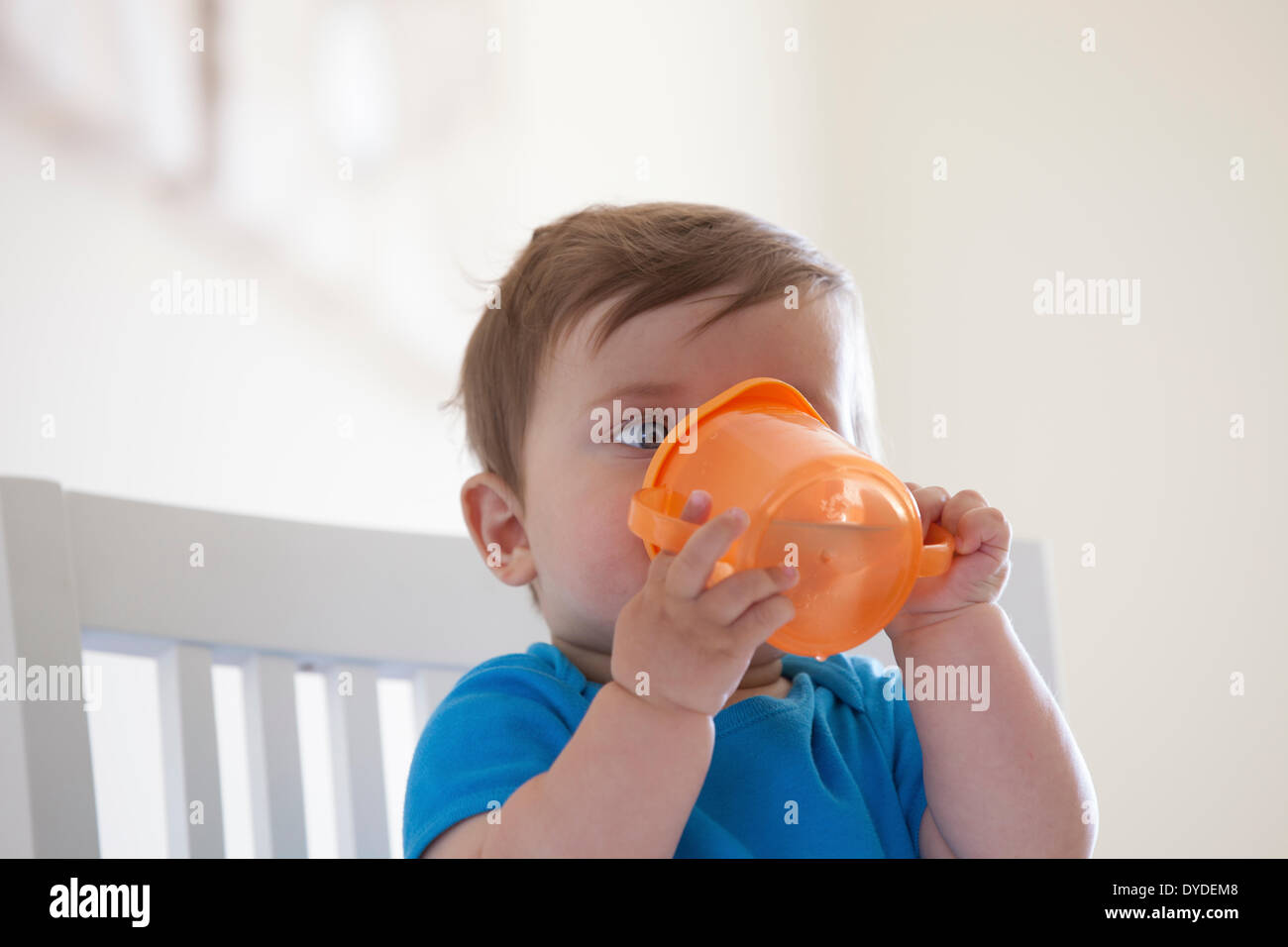 Young boy drinking from a cup Stock Photo - Alamy