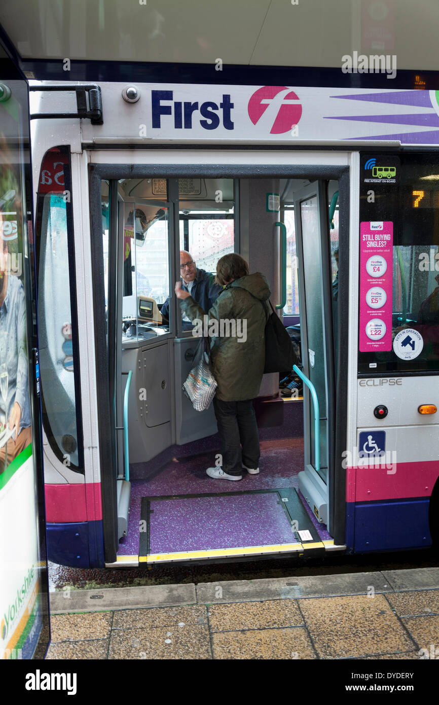 Passenger talking to driver on First public bus at bus stop Stock Photo ...