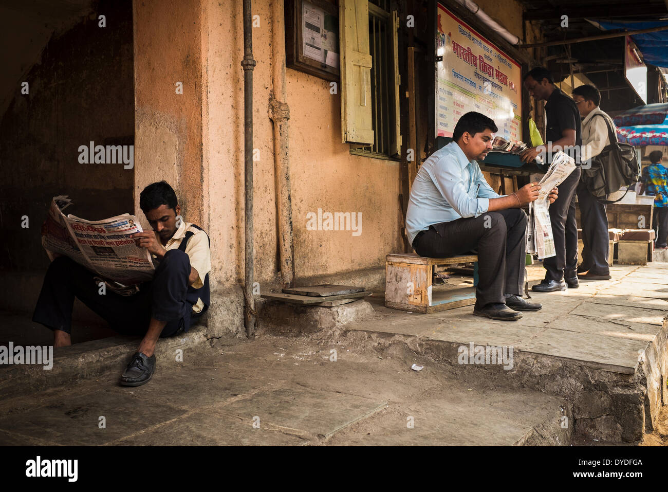 A group of men reading newspapers at a public reading booth Stock Photo ...