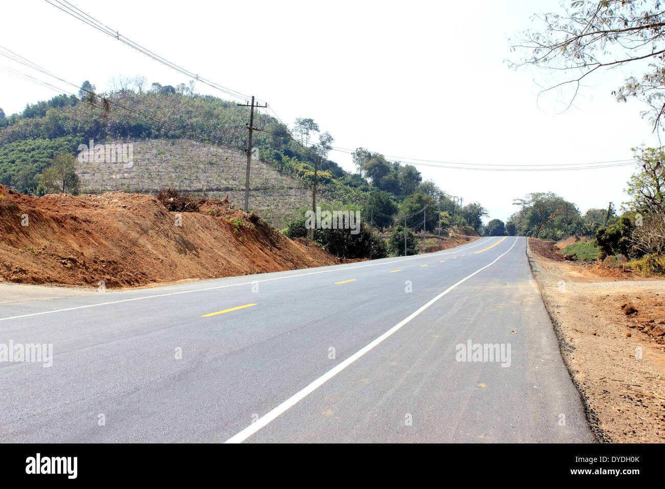 A Country Asphalt road in strong flare Stock Photo - Alamy