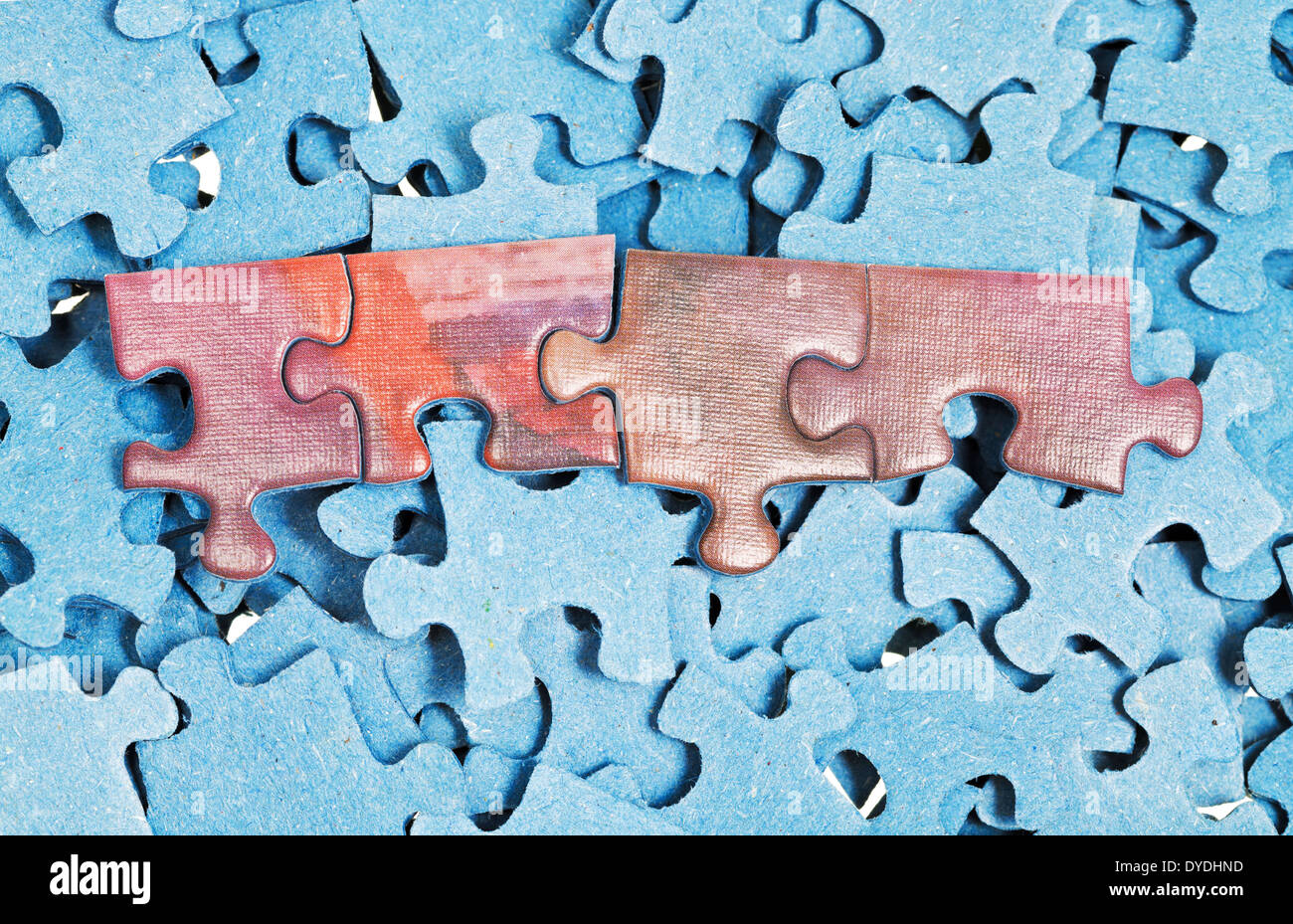 few connected pieces on pile of separated jigsaw puzzles Stock Photo ...