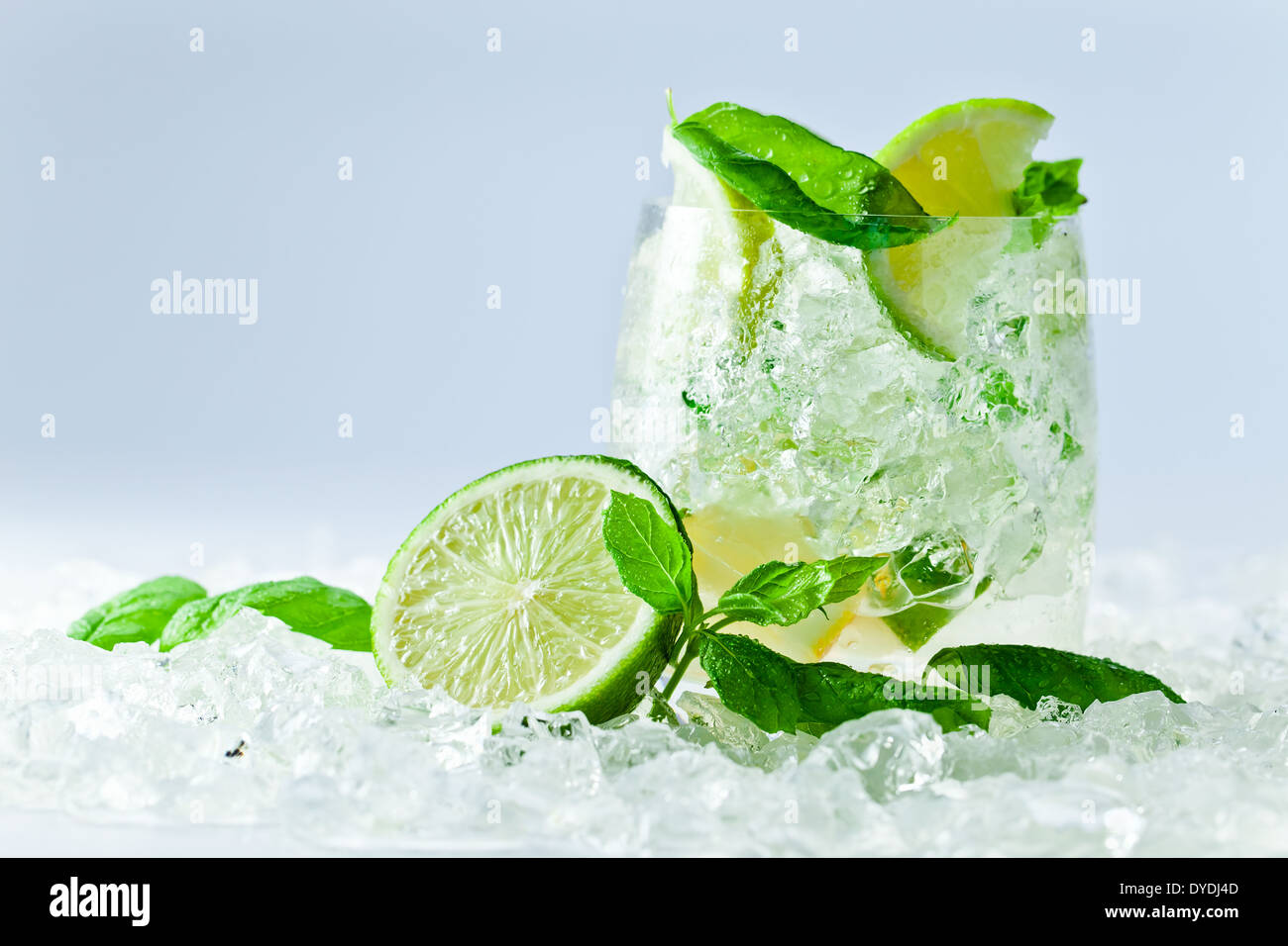 lime pieces and leaves of mint with ice Stock Photo - Alamy