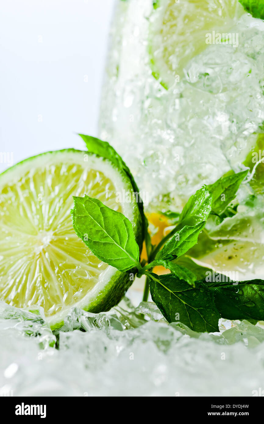 lime pieces and leaves of mint with ice Stock Photo - Alamy
