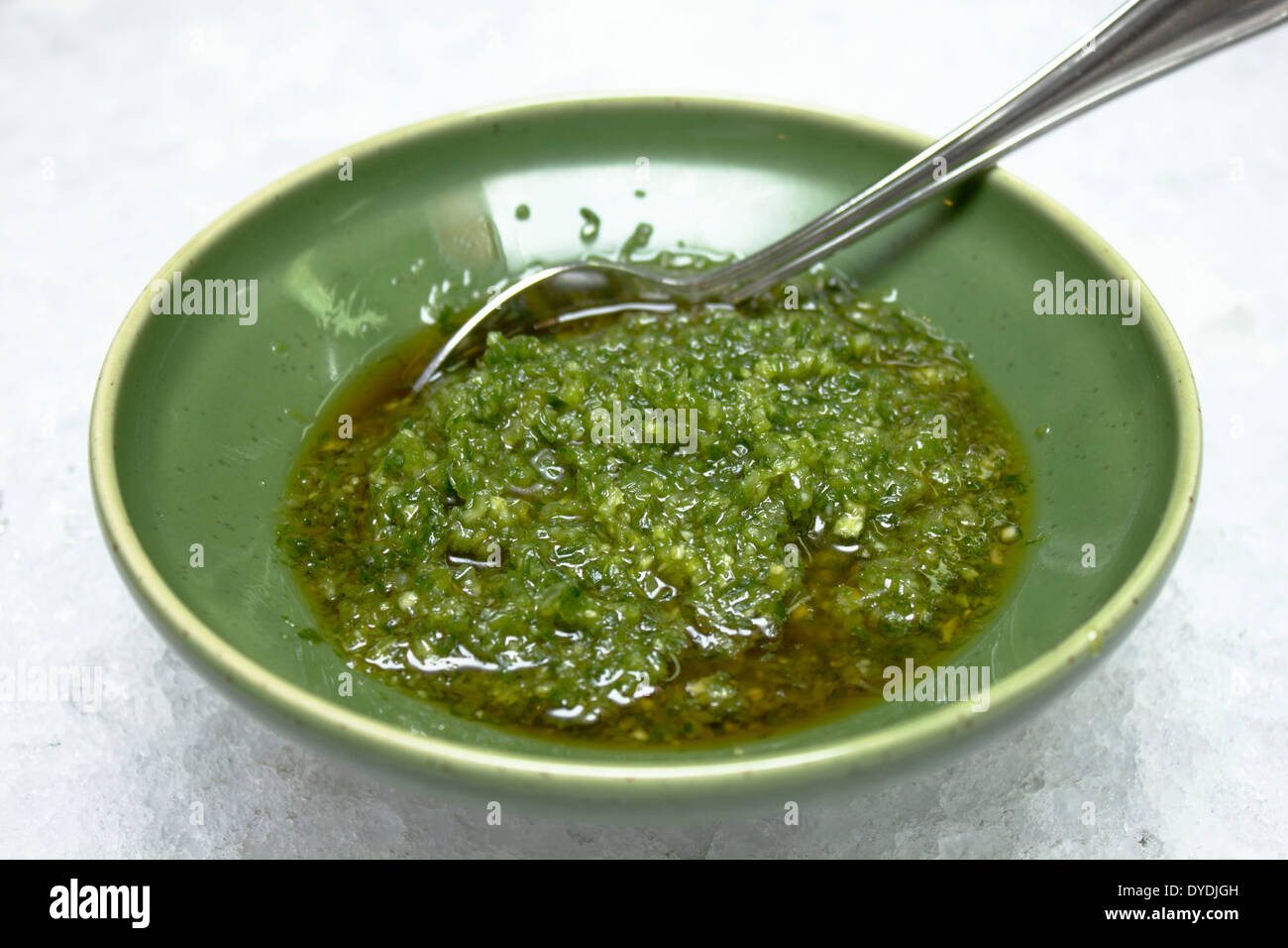 Green chilli shaker in a green bowle Stock Photo - Alamy