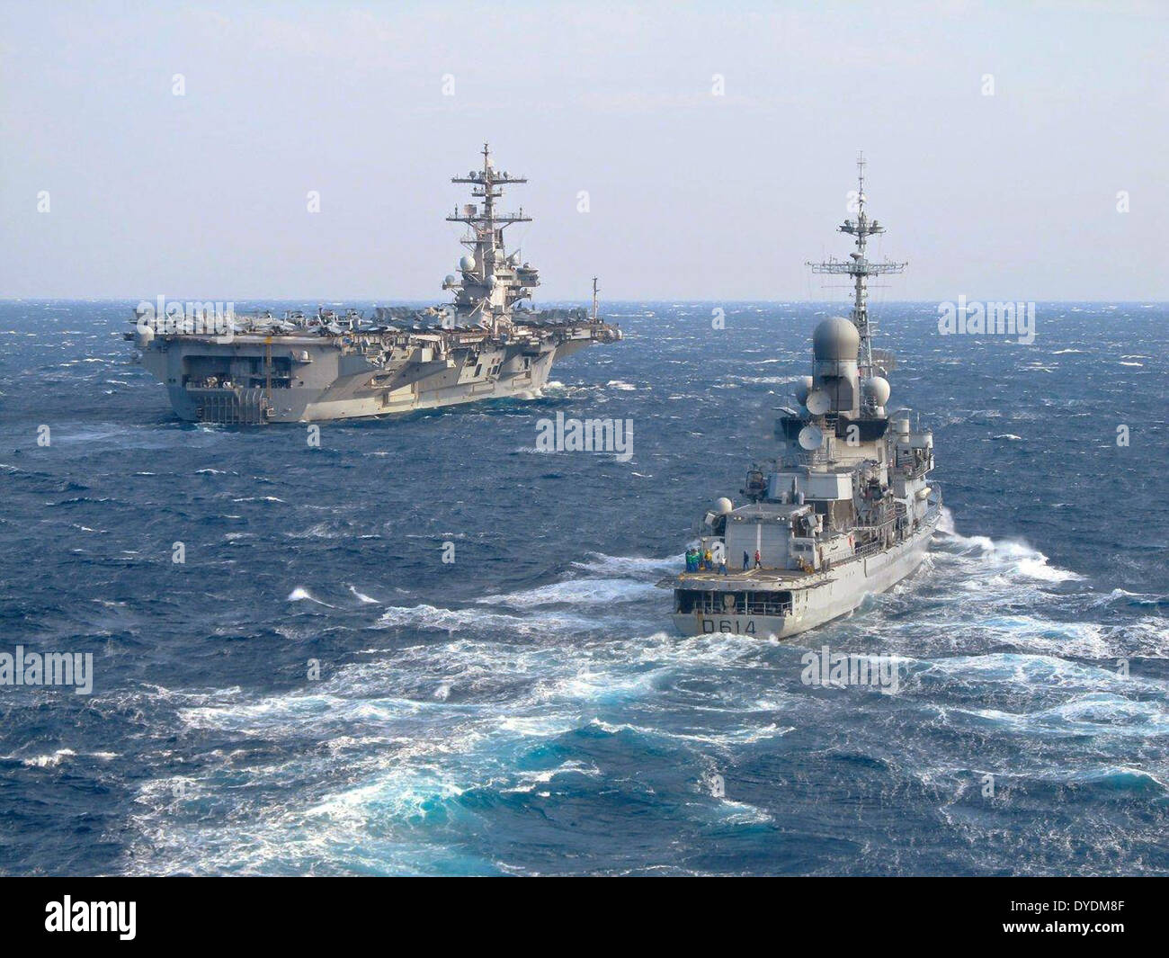 The French navy frigate FS Cassard passes alongside the aircraft carrier USS George H.W. Bush ...