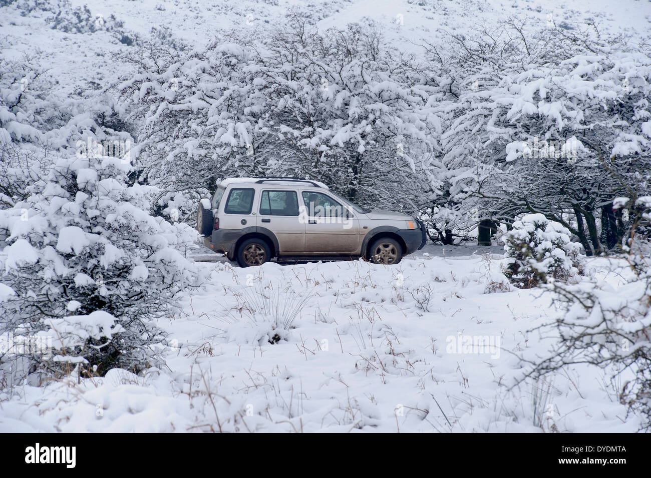 A 4x4 Land Rover drives across Exmoor in the snow in winter, UK Stock ...
