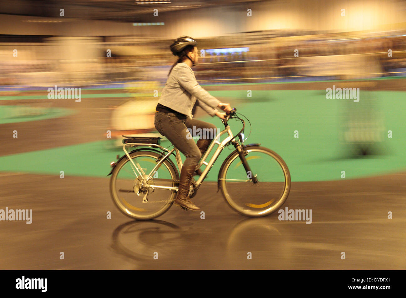 Woman on an electric bicycle moving at speed at the Gadget Show Live ...