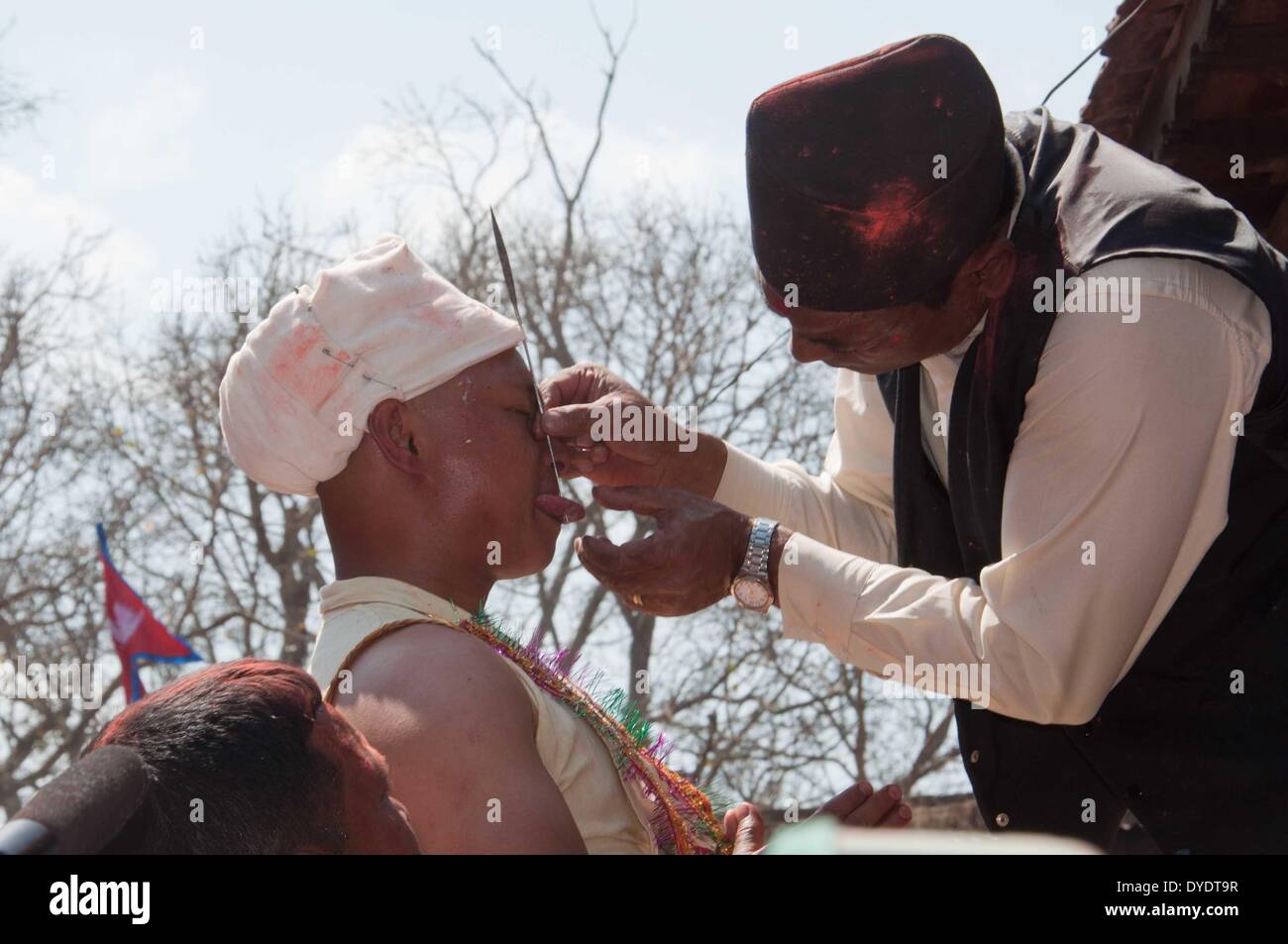 Bhaktapur, Nepal. 15th Apr, 2014. A man gets his tongue pierced during ...