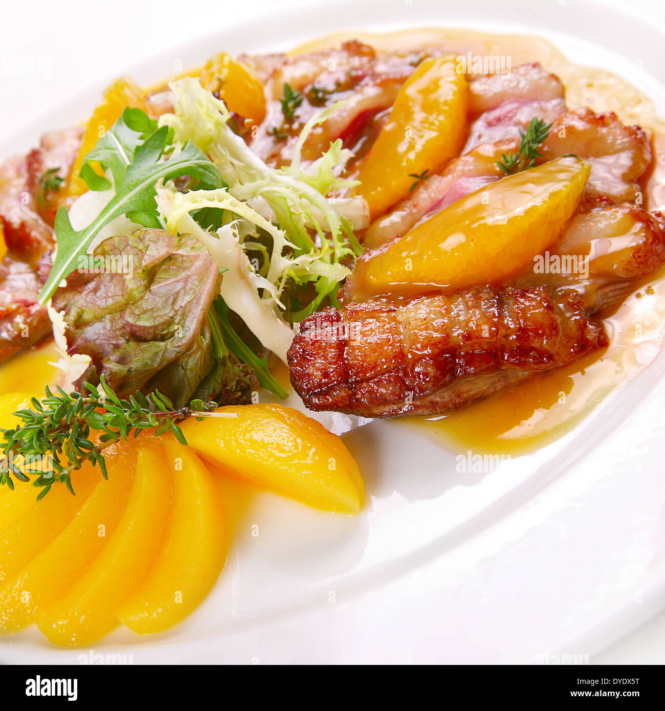 Fried meat with fruit orange and mango Stock Photo - Alamy