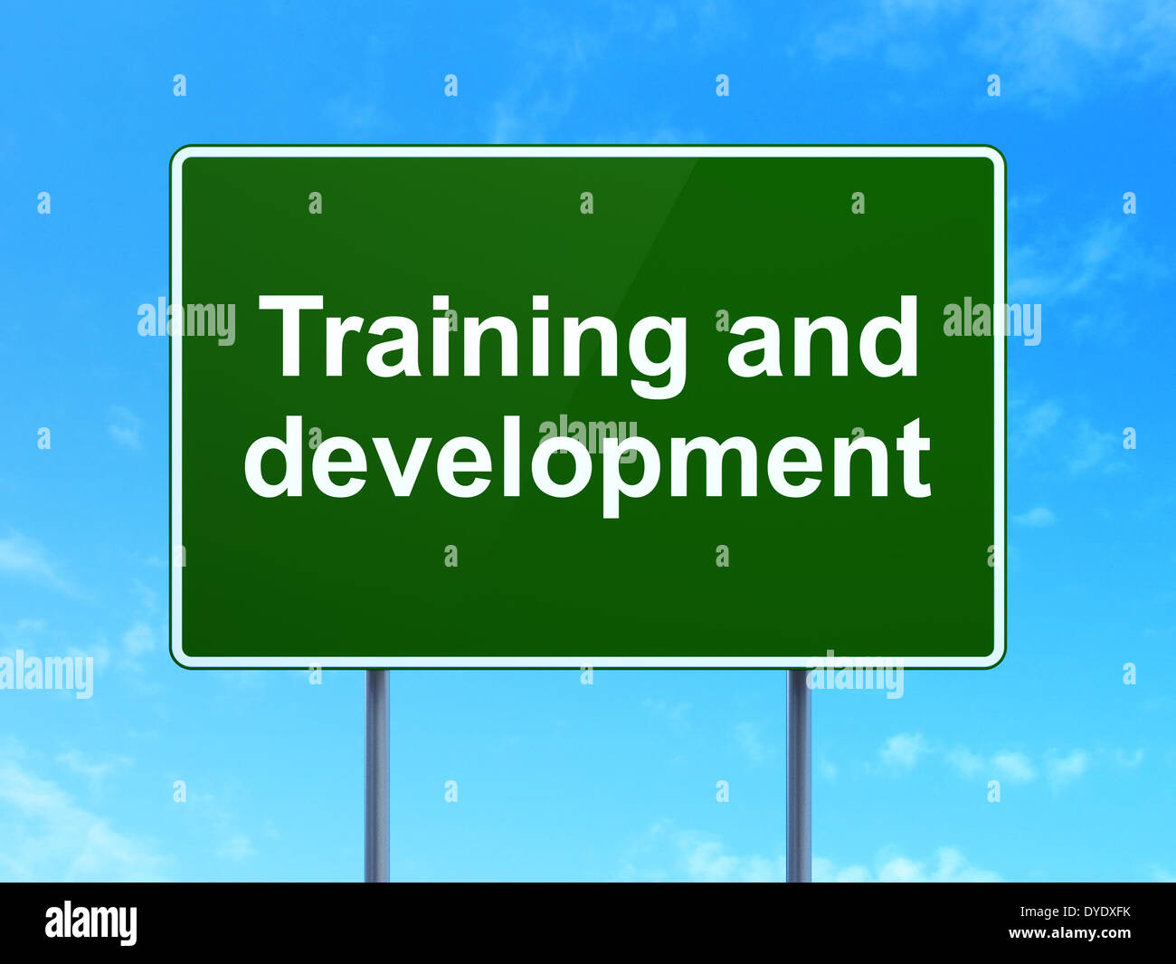 Education concept: Training and Development on road sign background ...