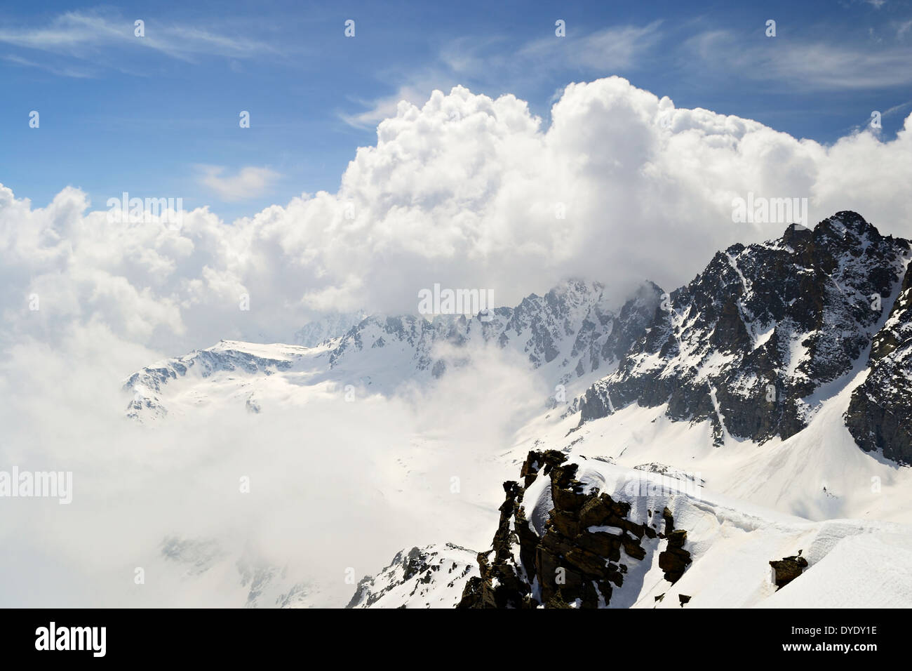 High mountain range in spring with raising clouds from below. Italian ...