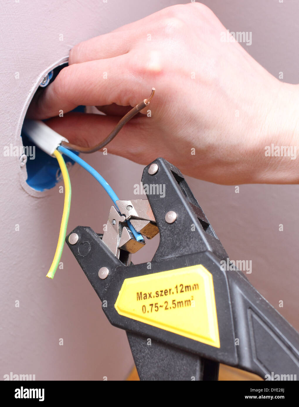 Electrician insulating electric wires of an electric box Stock Photo ...