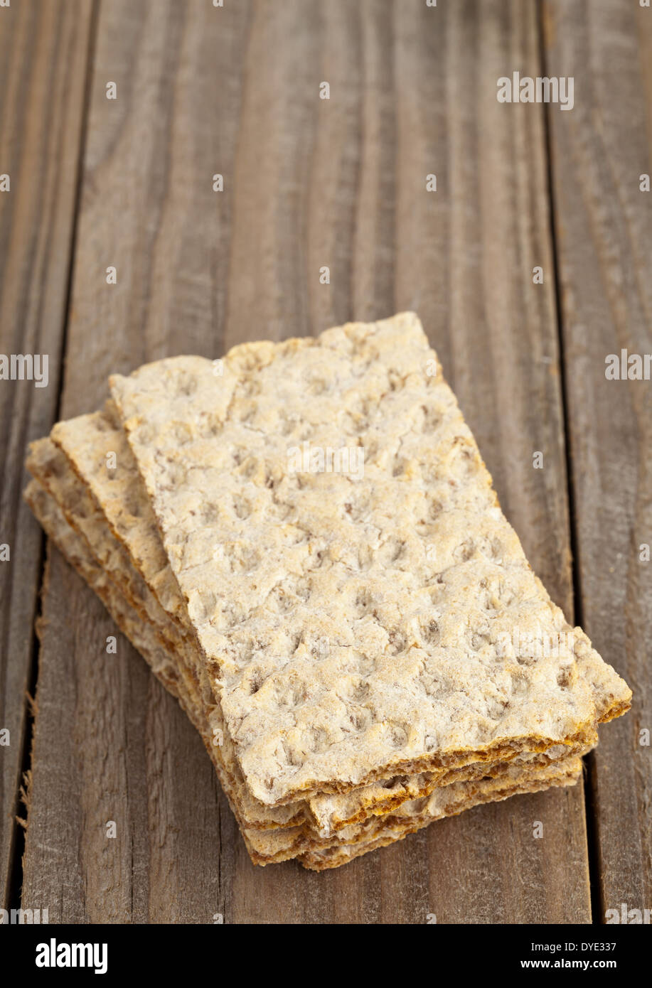 Multiple slices of wheat crispbread on wooden table Stock Photo - Alamy