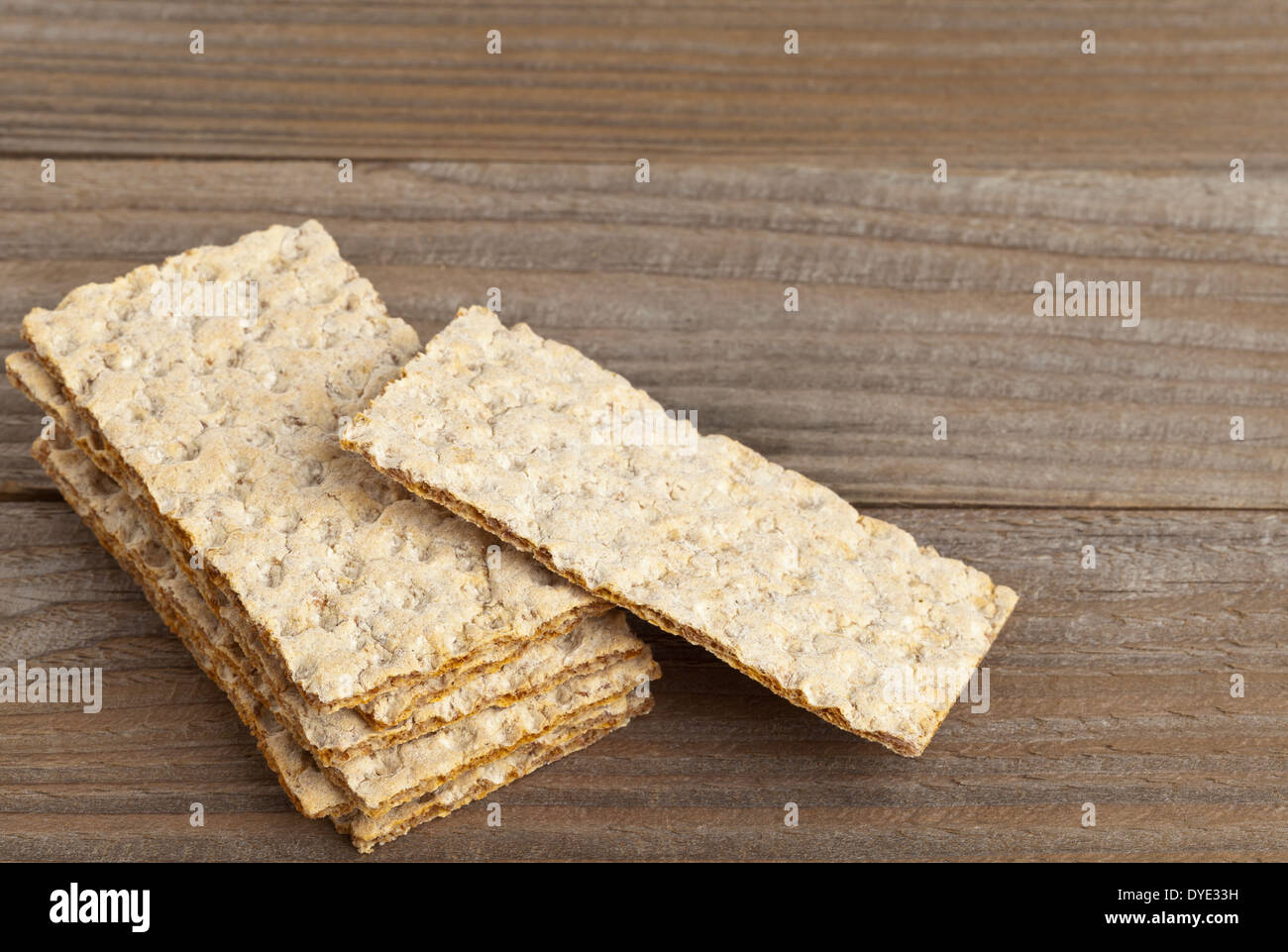 Multiple slices of wheat crispbread on wooden table Stock Photo - Alamy