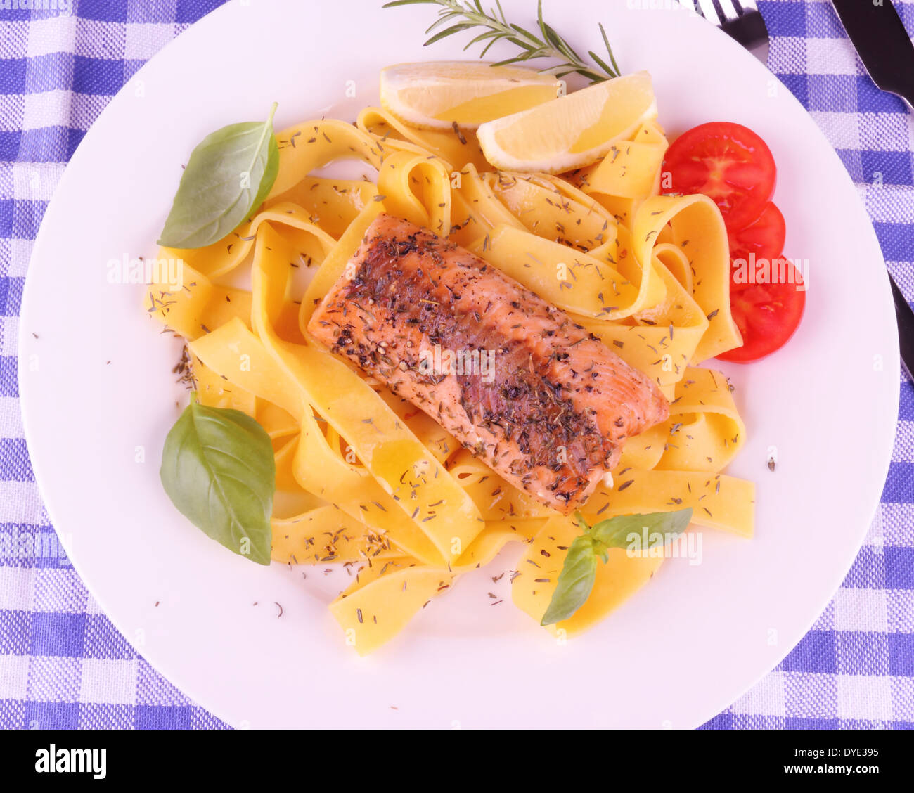 Salmon fillet on tagliatelle, lemon, herbs, top view Stock Photo - Alamy