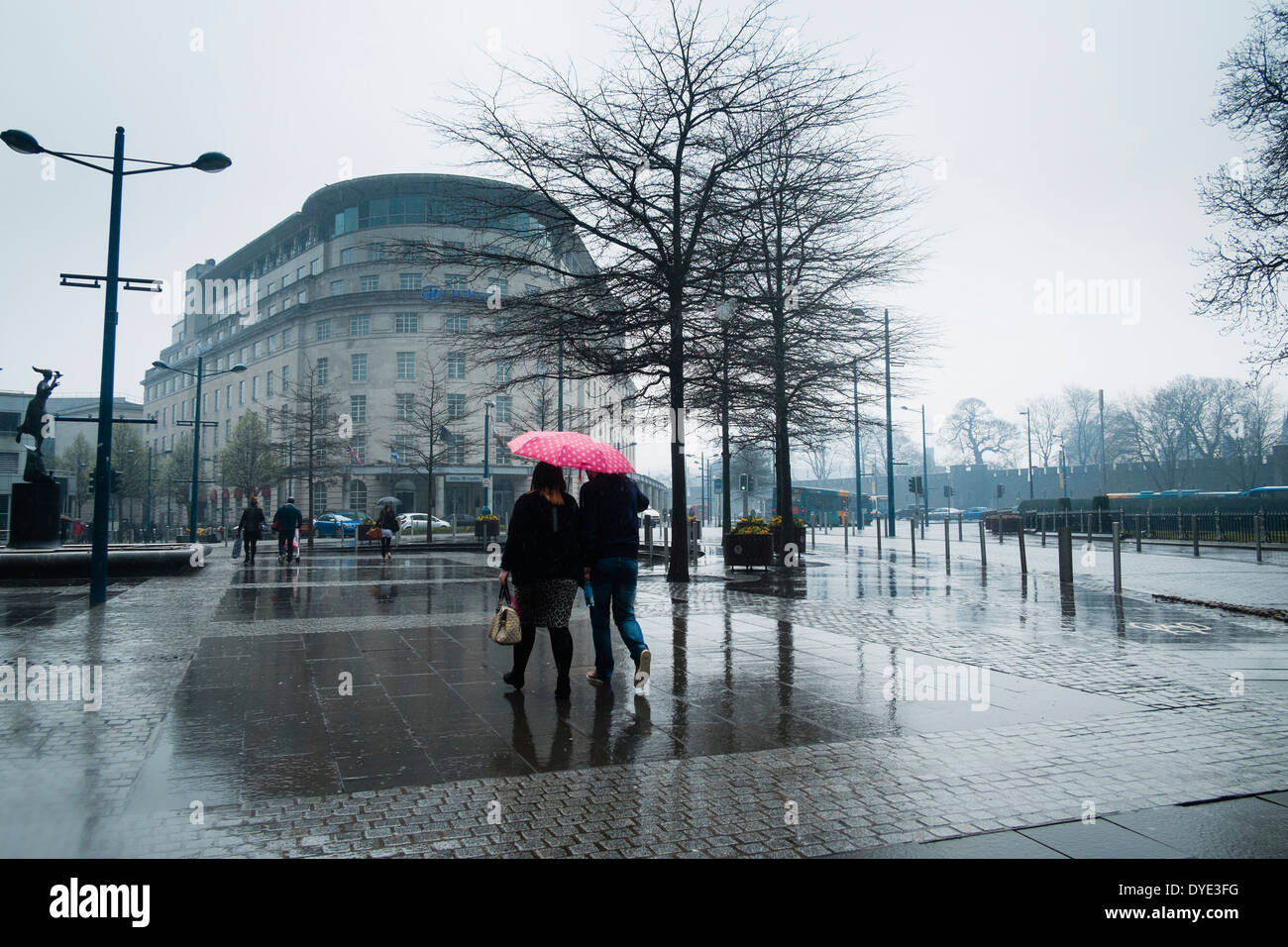 People In The Rain With Umbrellas