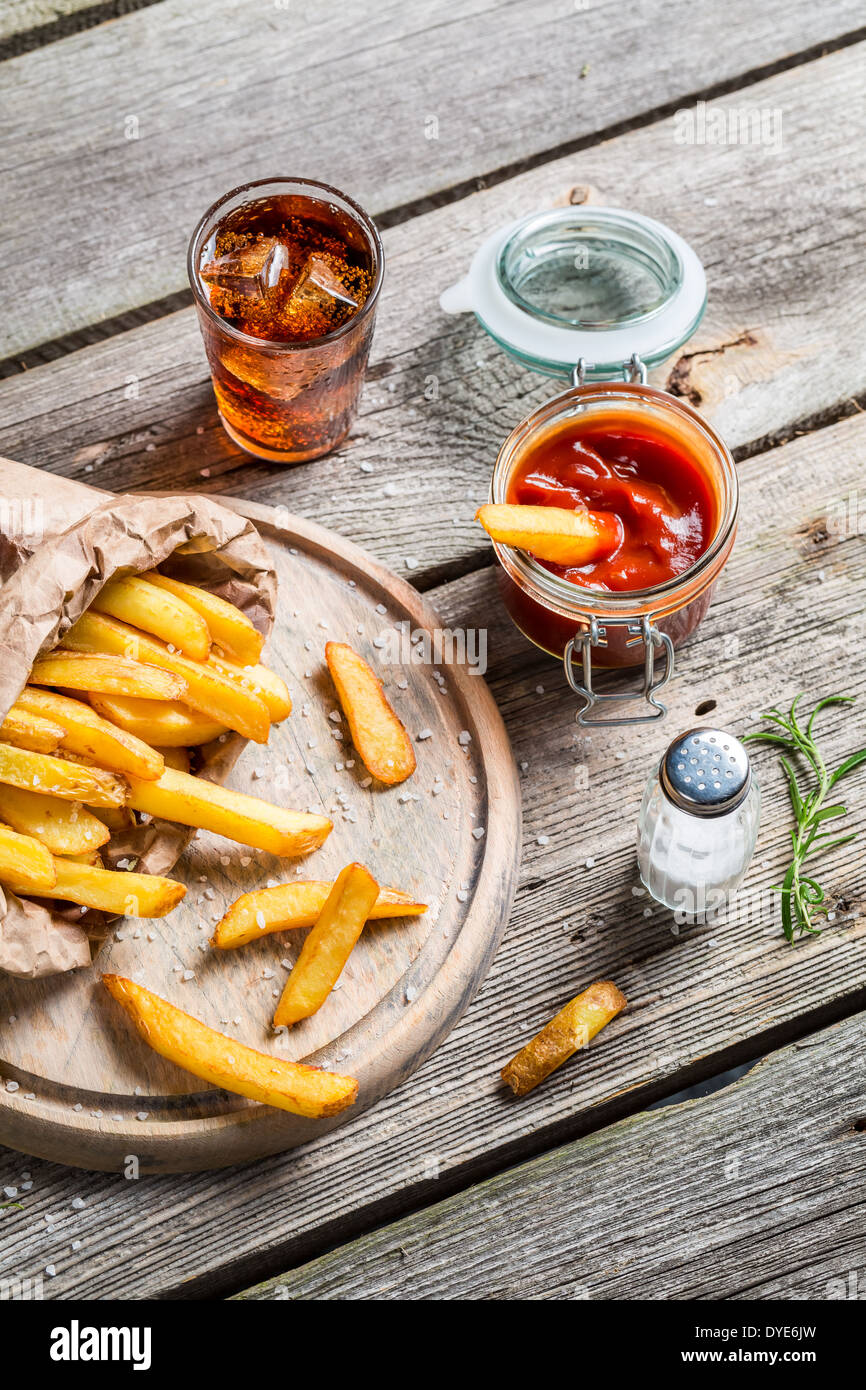 Fresh french fries served with cold drink Stock Photo - Alamy