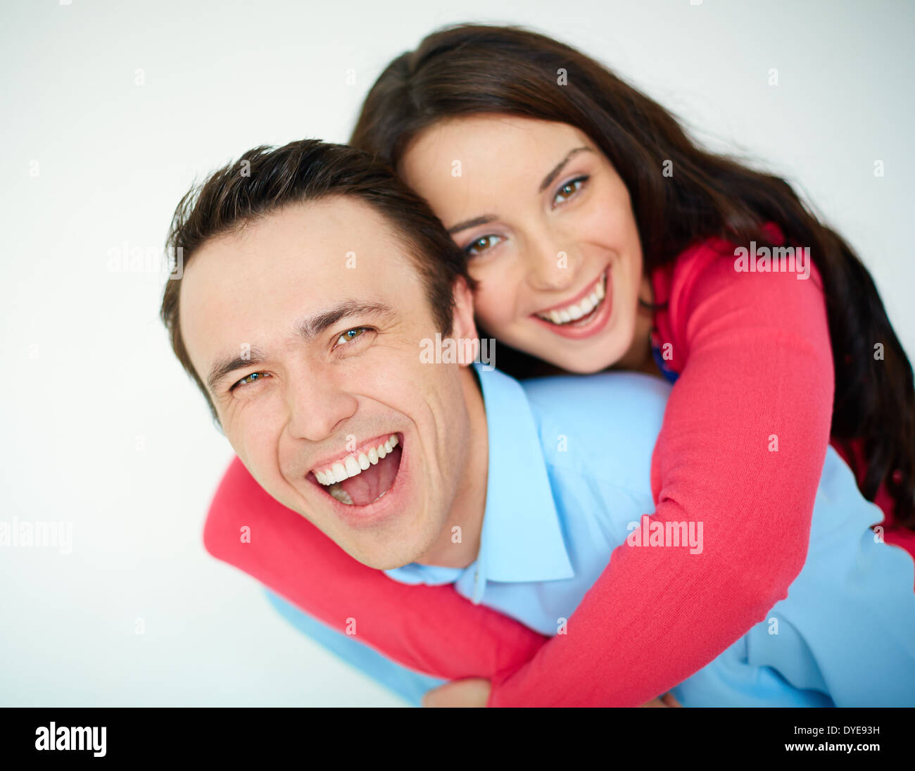 Portrait of amorous young woman embracing her happy husband Stock Photo ...