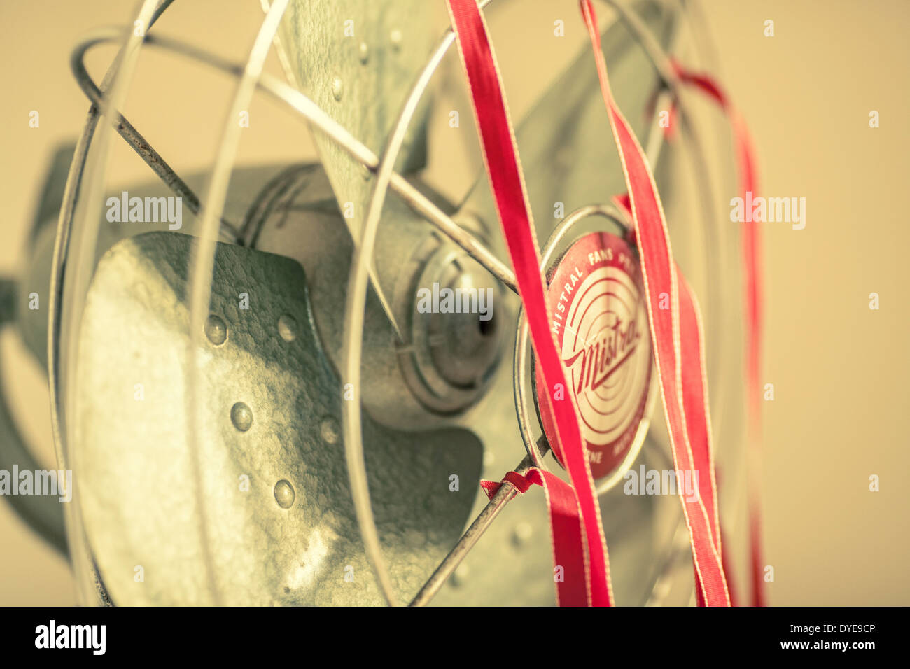 An old green desk fan with red ribbons against a white background Stock ...