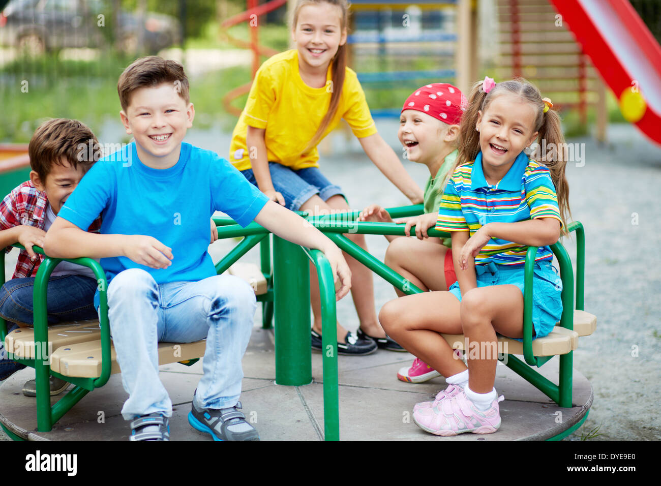 Image of cute friends having fun on carousel outdoors Stock Photo - Alamy