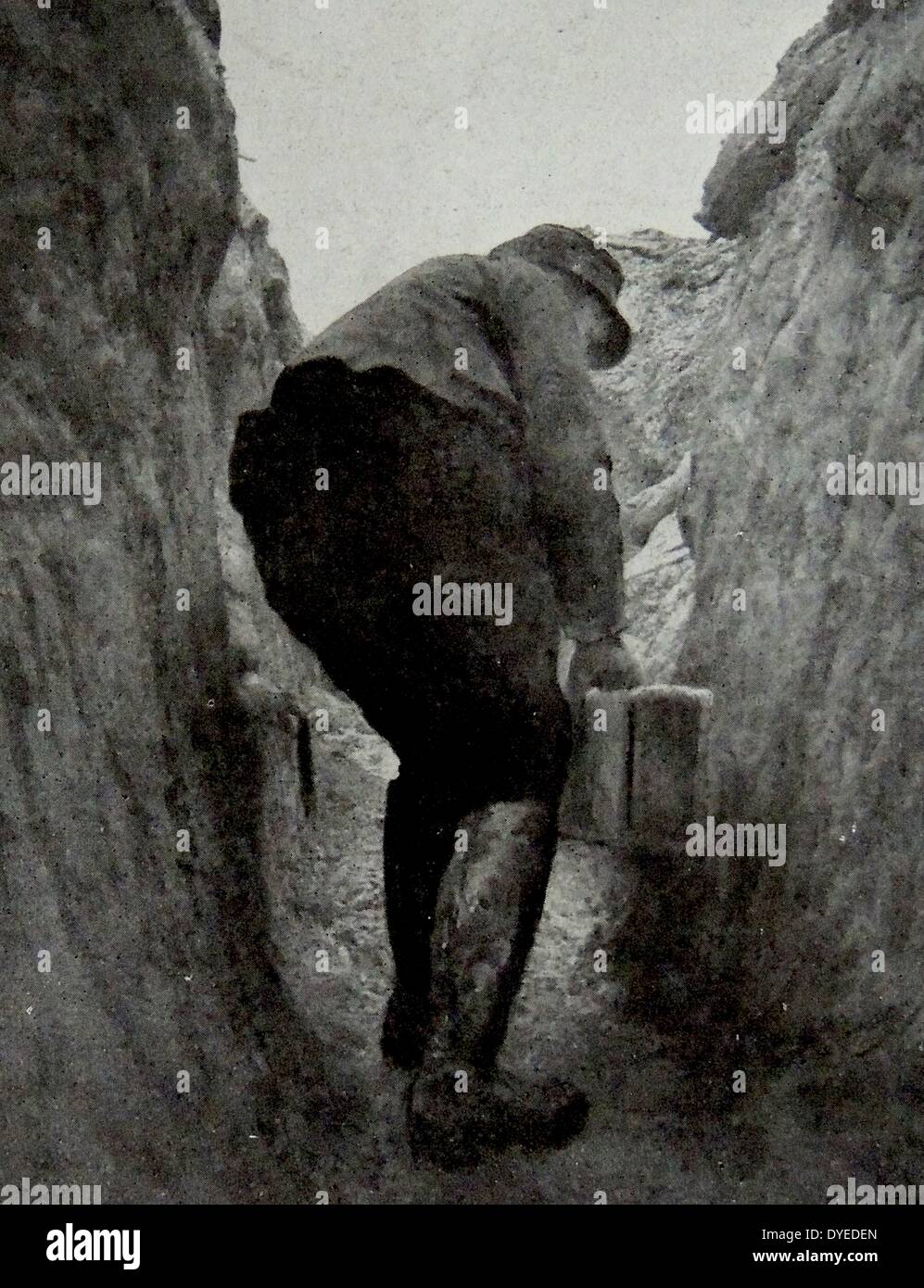 French soldier uses a periscope whilst in the trenches to maintain ...