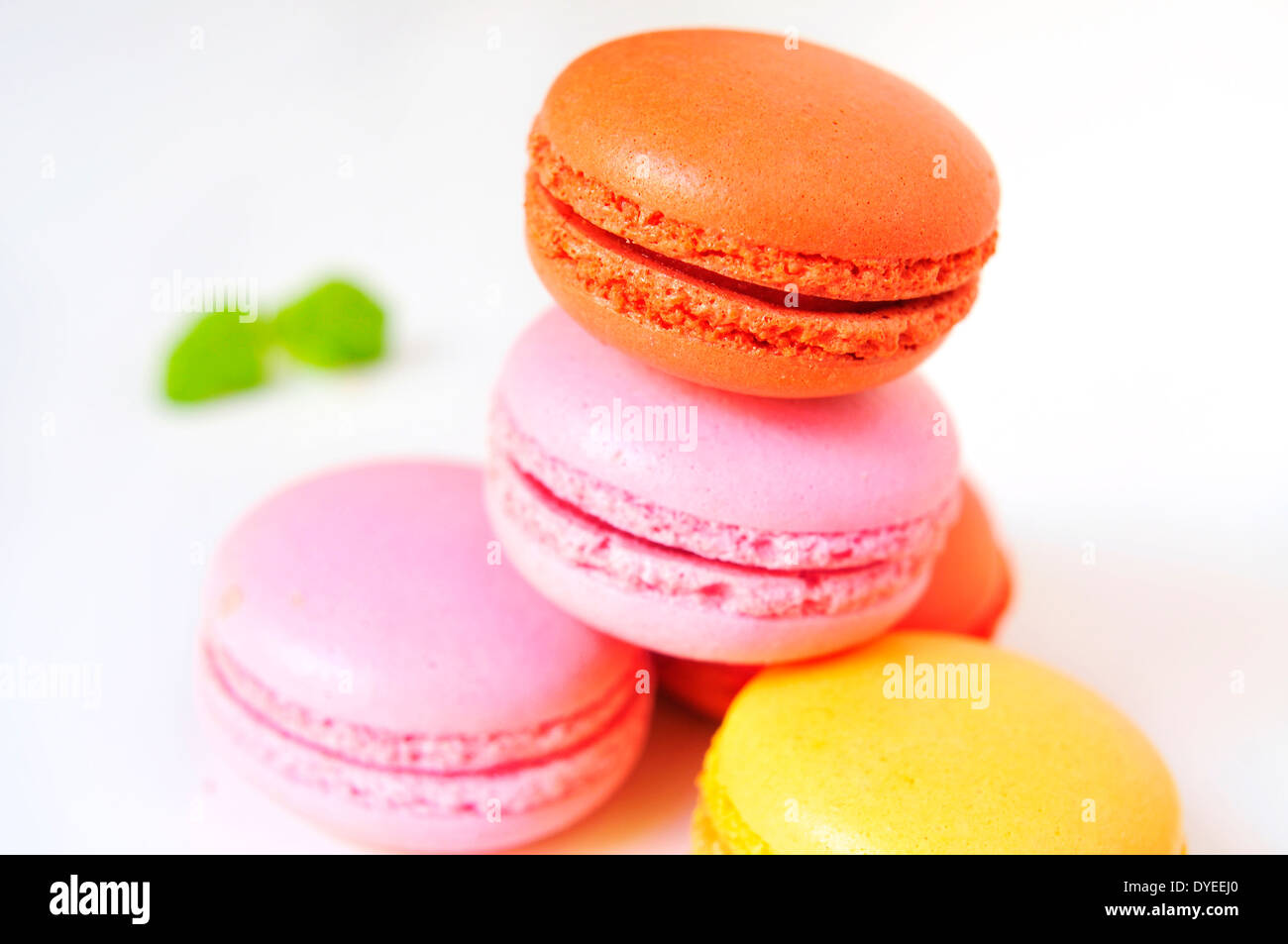 some appetizing macarons with different colors and flavors on a white ...