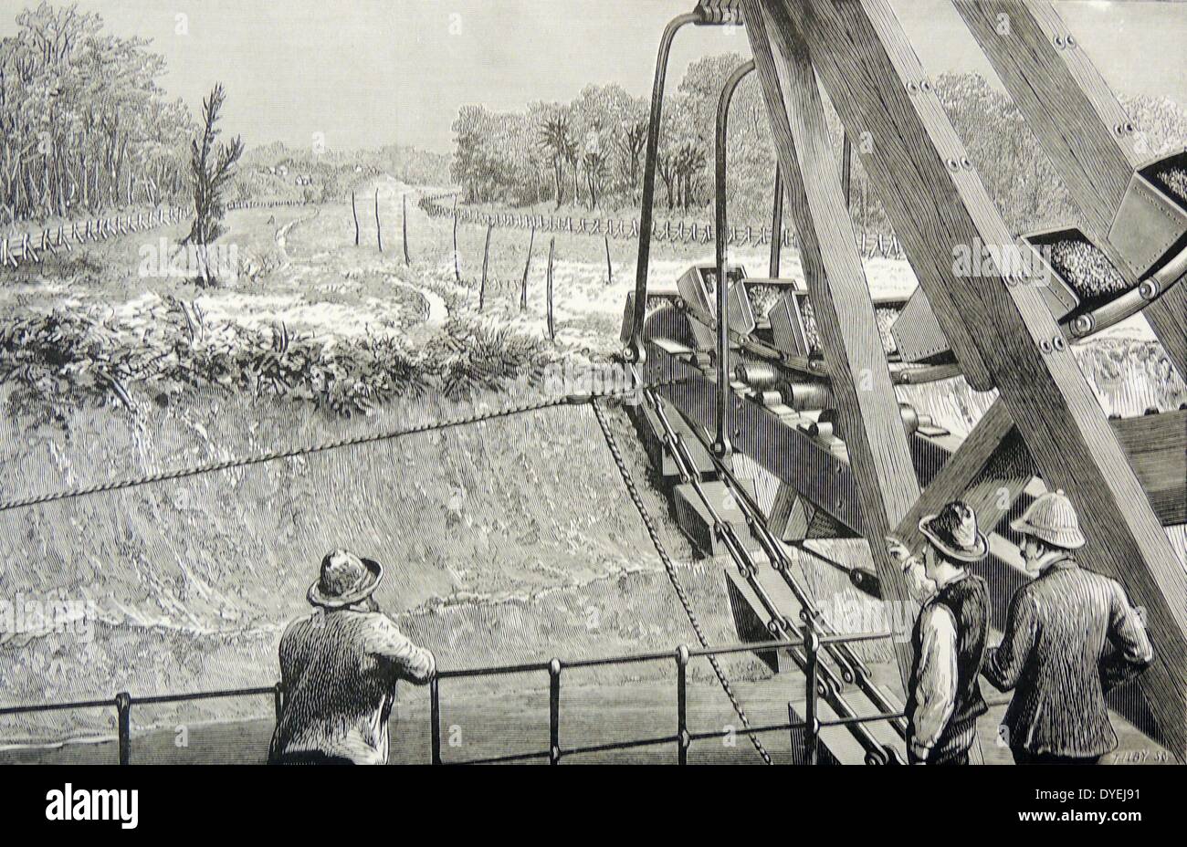 A dredger digging through a clearing cut in the forest during the de ...