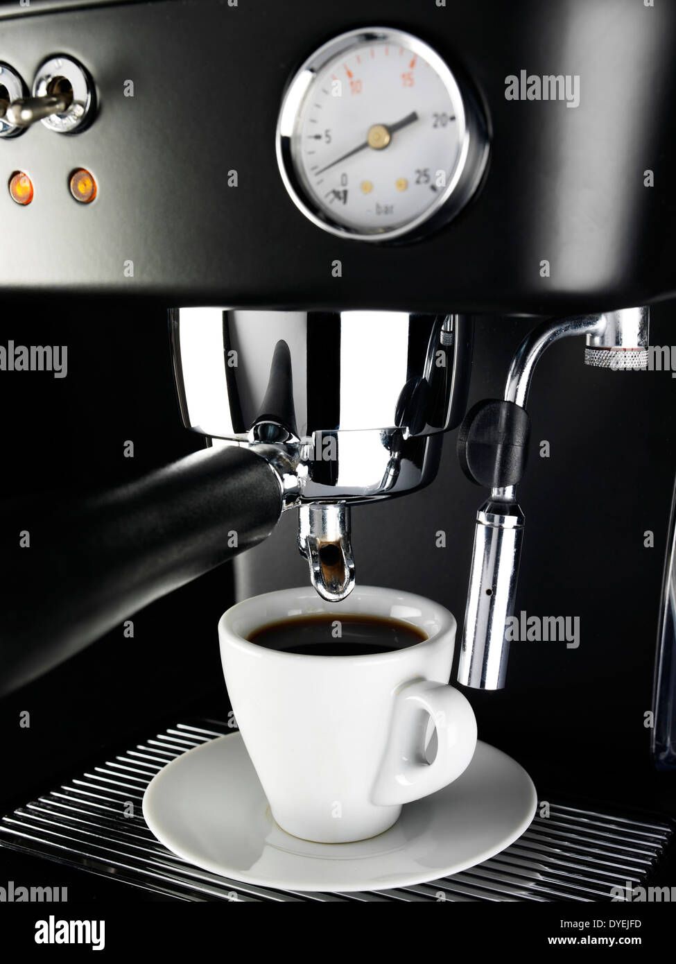 CLOSE UP OF A FRESHLY MADE CUP OF COFFEE BEING PREPARED WITH AN ...