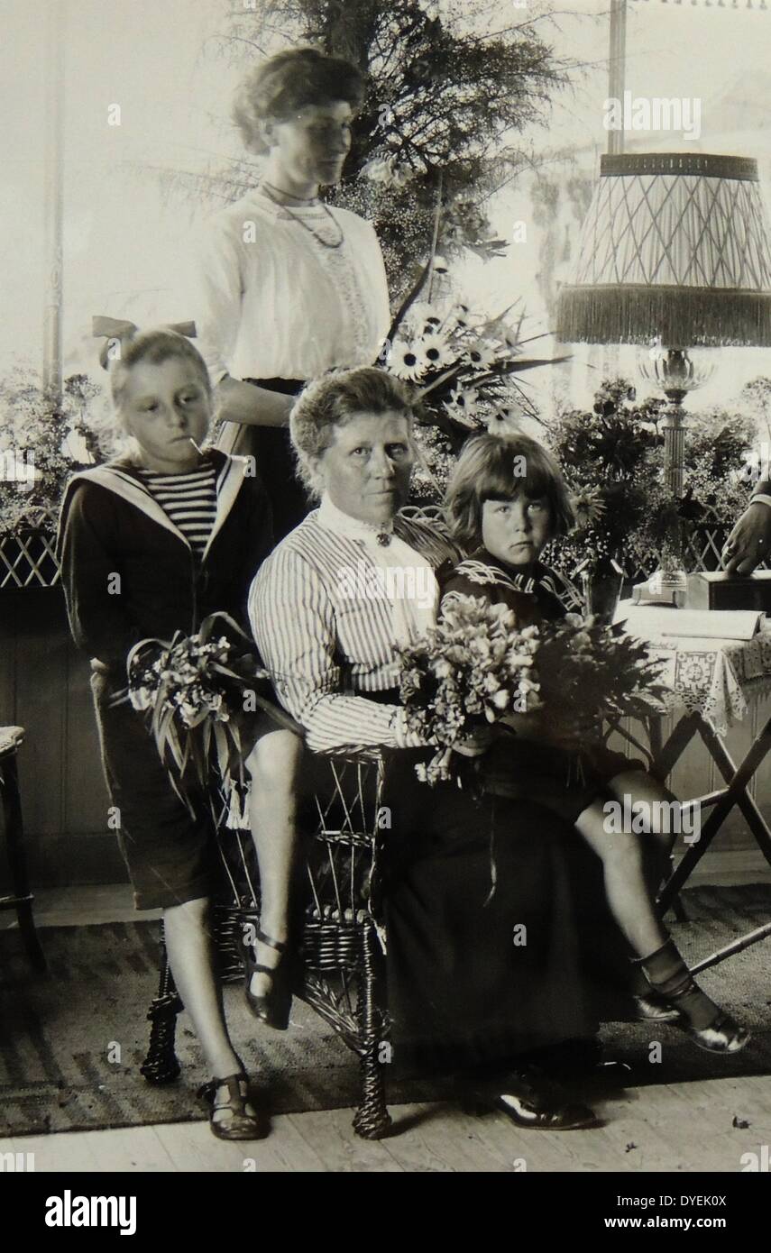 French family in a domestic setting. Three generations are shown ...