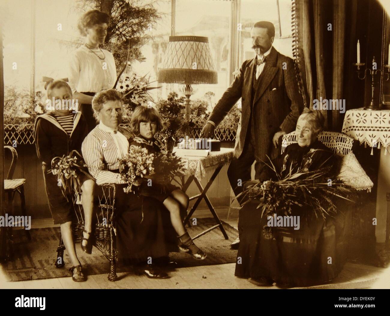 French family in a domestic setting. Three generations are shown ...