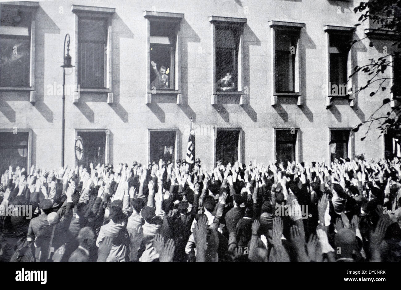 Nazi supporters gather to wave to Hitler as he looks from his office in ...