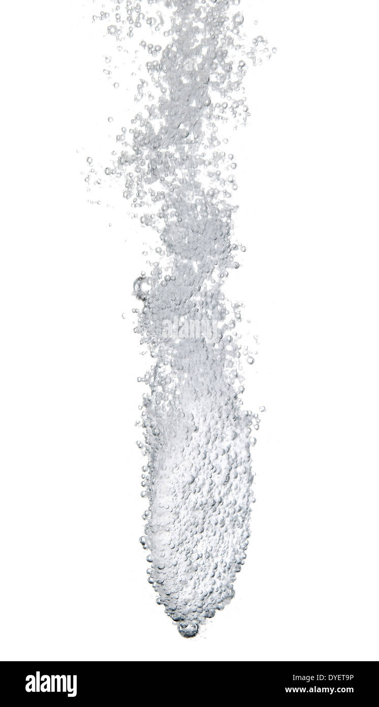 AN EFFERVESCING ALKA SELTZER DROPPING INTO WATER ON A WHITE BACKGROUND ...