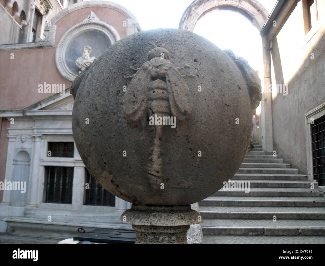 Stone sculpture of an orb covered in large relief versions of insects ...