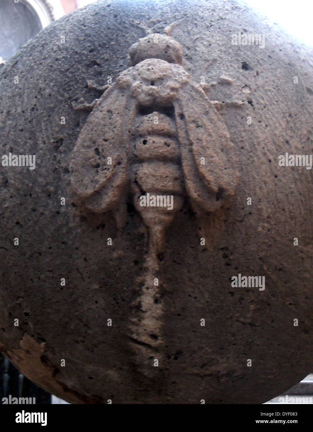 Stone sculpture of an orb covered in large relief versions of insects ...