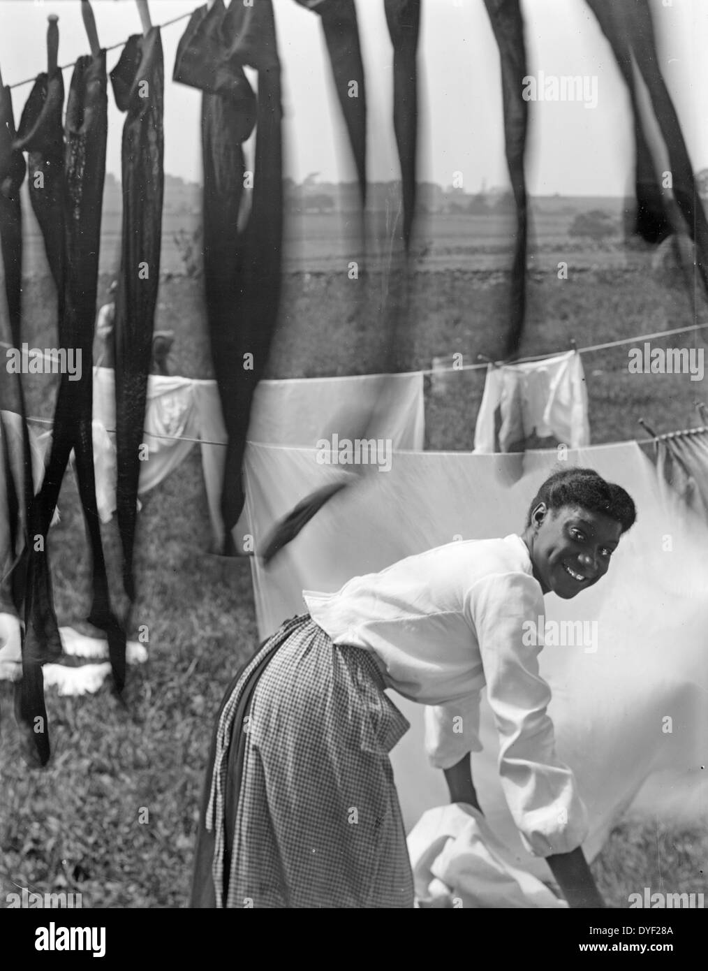 Black and white, an informal portrait of a young Negro woman surrounded ...
