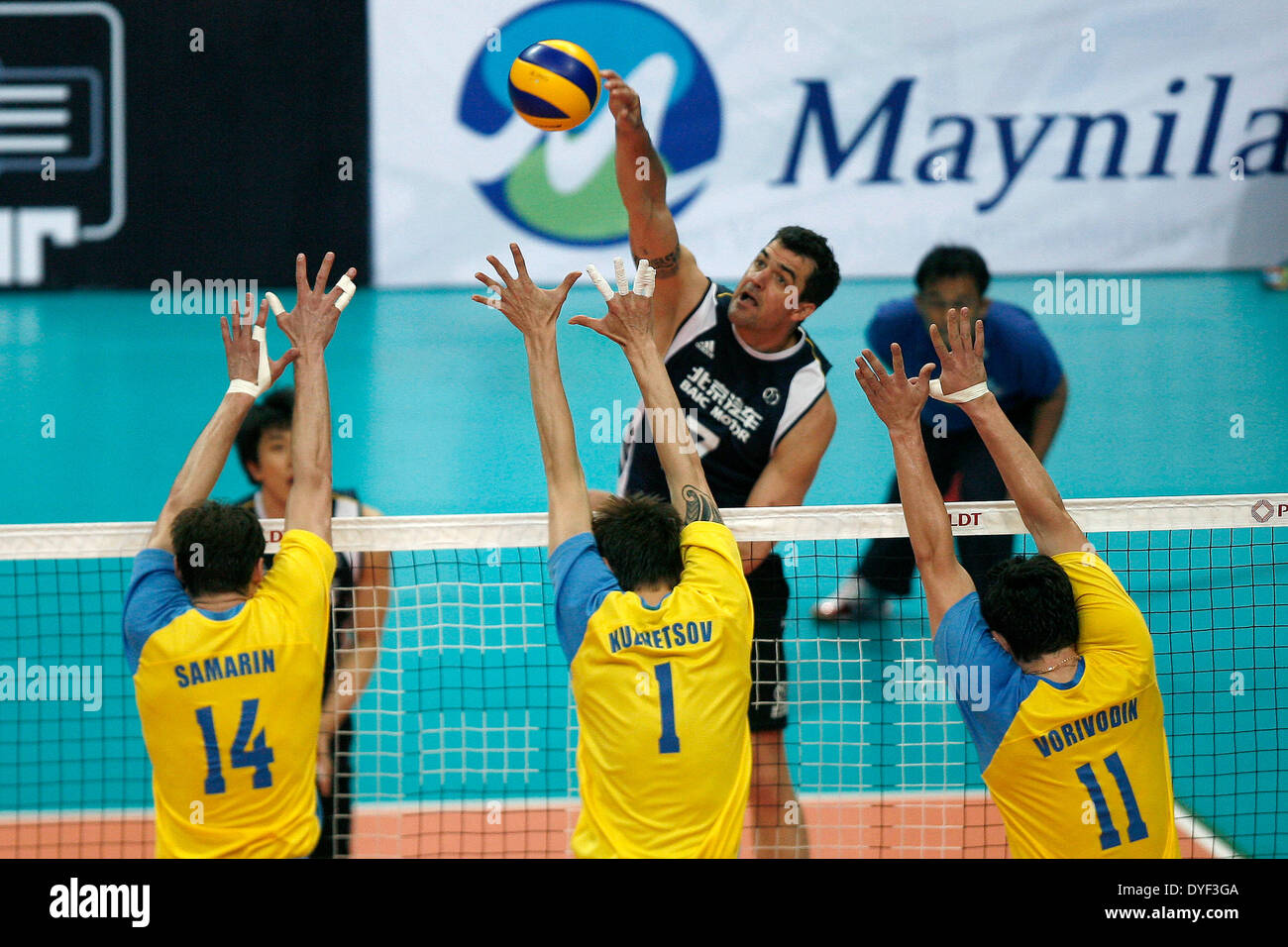 Pasay City, Philippines. 16th Apr, 2014. Wout Tijismans (top) of China spikes the ball against ...