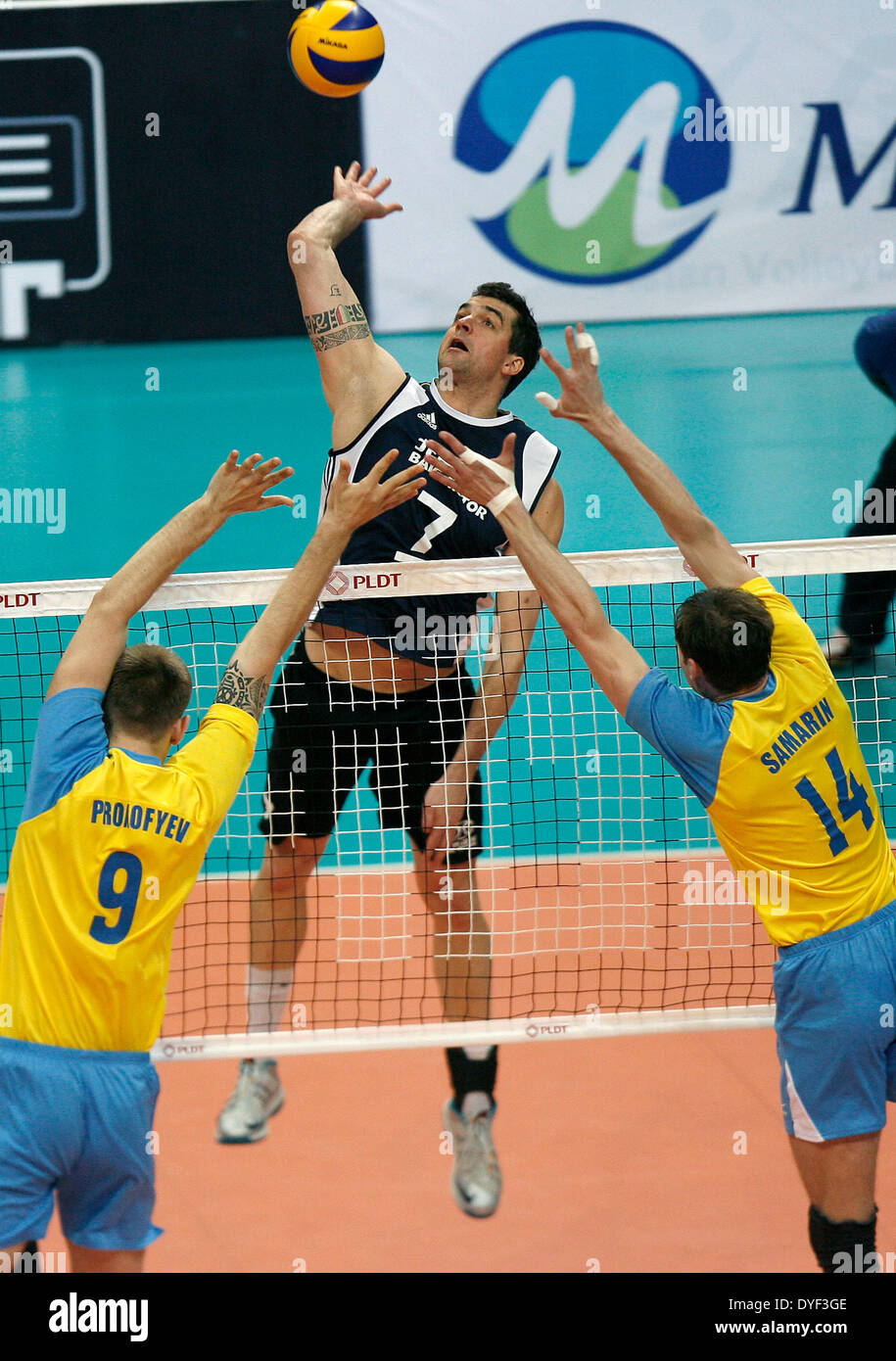 Pasay City, Philippines. 16th Apr, 2014. Wout Tijismans (C) of China spikes the ball against ...