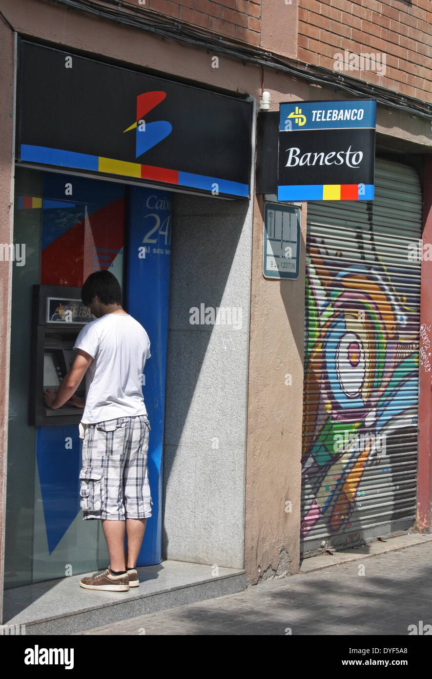 Spain barcelona spanish man cash atm machine capitalism economy bank hi ...