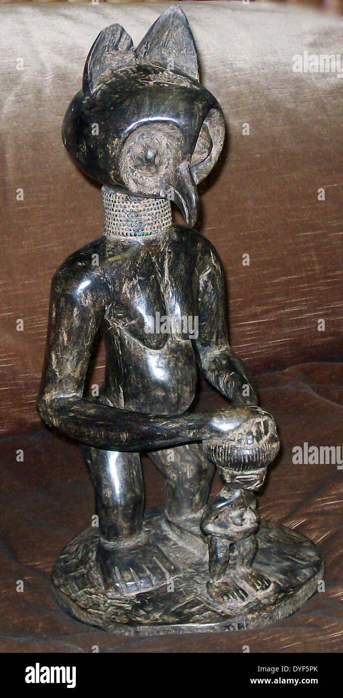 Tribal art: Owl-headed figure protecting a small child. Wood carving ...